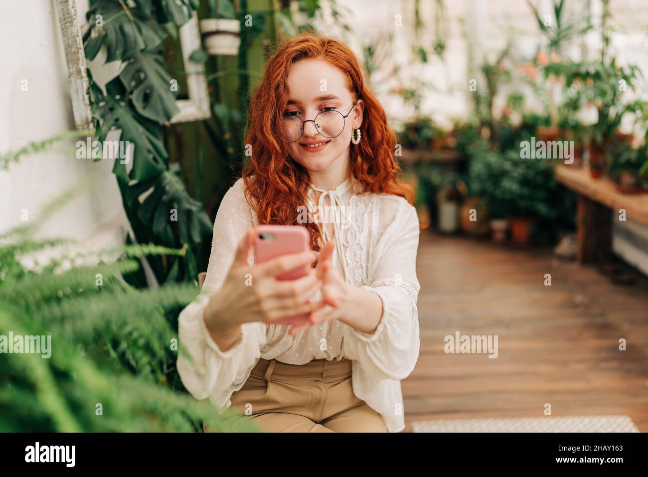 Side view of happy female in decorative deer horns cuddling adorable ...