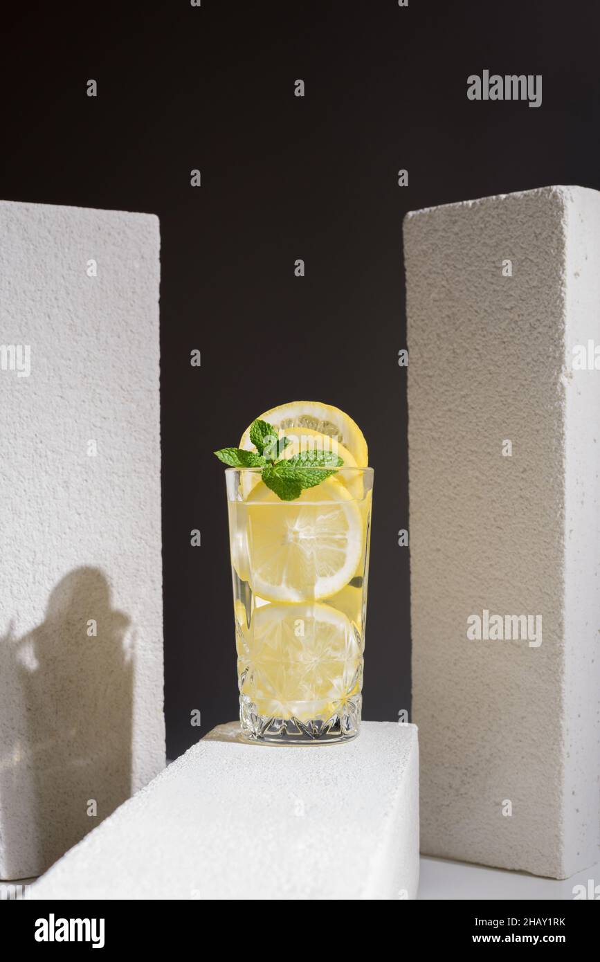 Glass of cold fresh lemonade with slices of lemon and leaves of mint ...