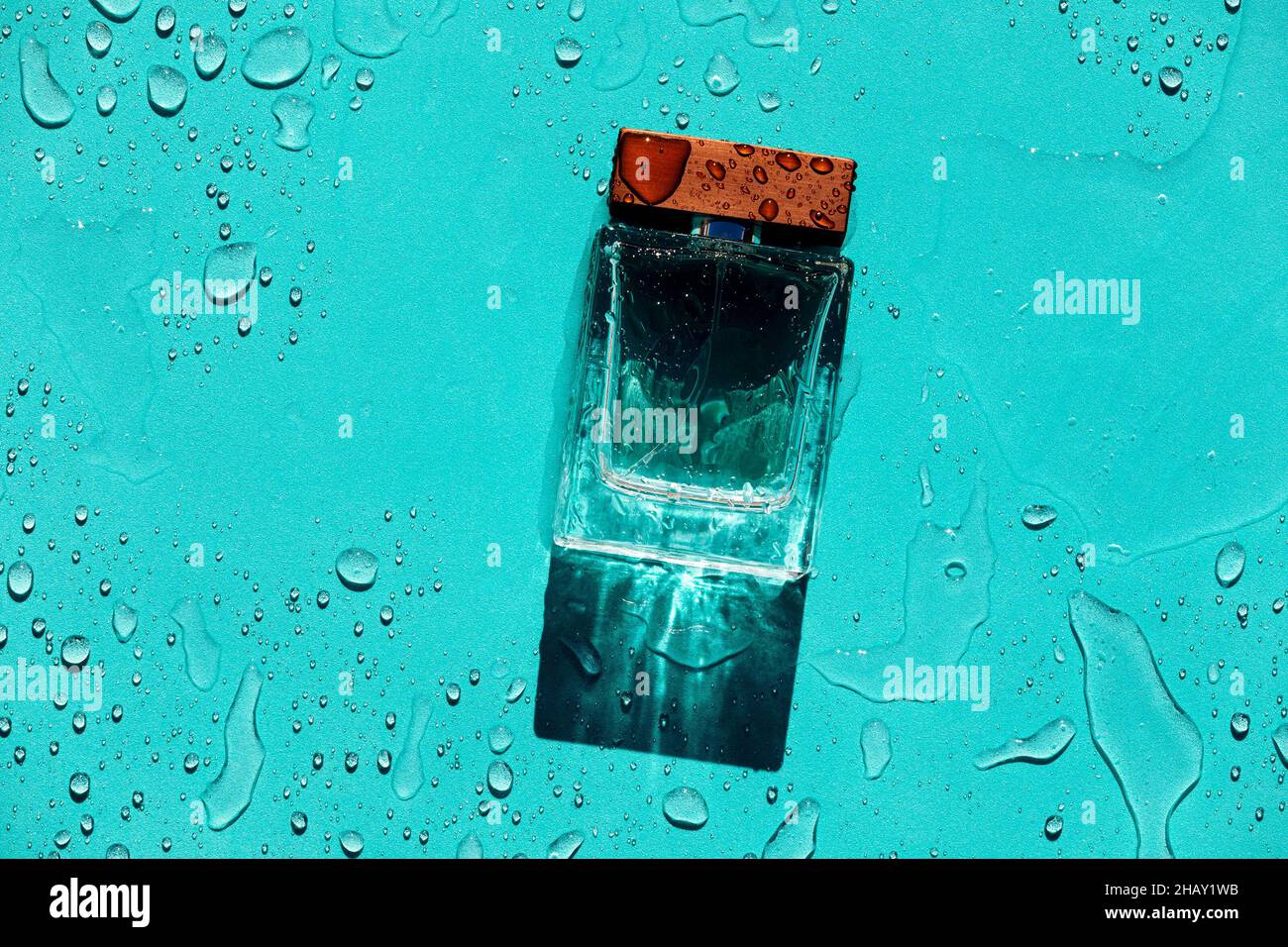 Top view of transparent glass bottle with aromatic perfume placed on ...