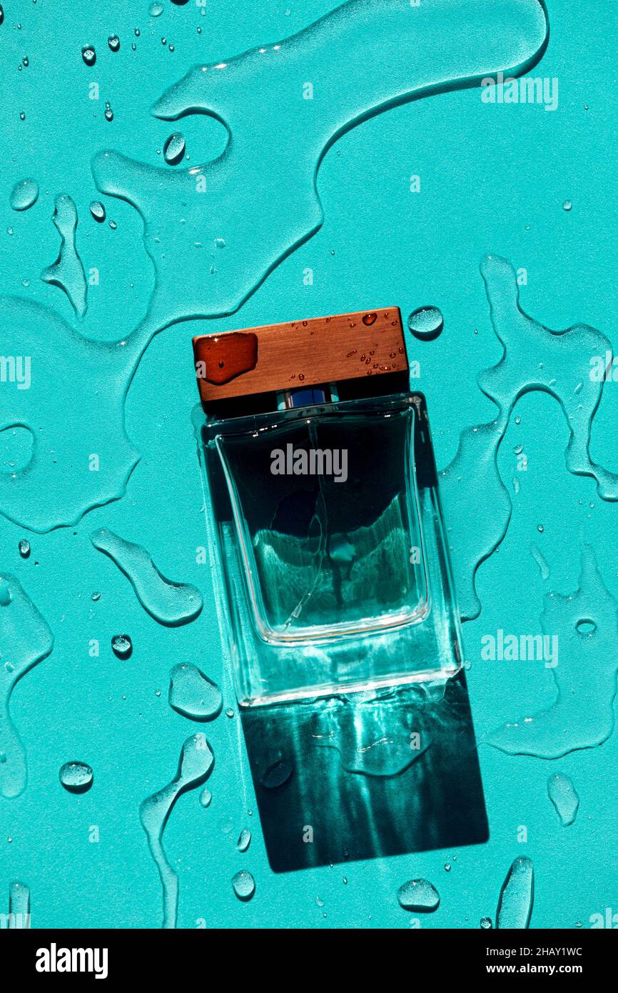 Top view of transparent glass bottle with aromatic perfume placed on ...