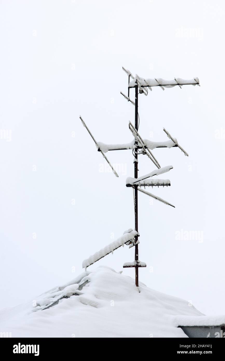 The TV antenna is covered with snow on the roof. Cold winter, , icicle ...