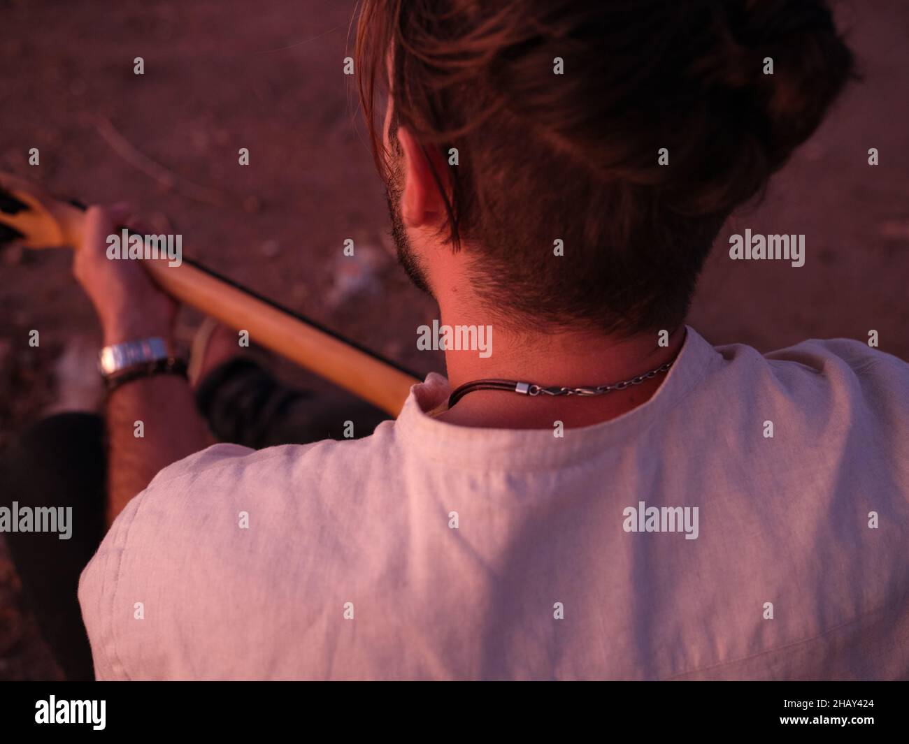 cut out view from behind of a seated man playing the guitar Stock Photo ...