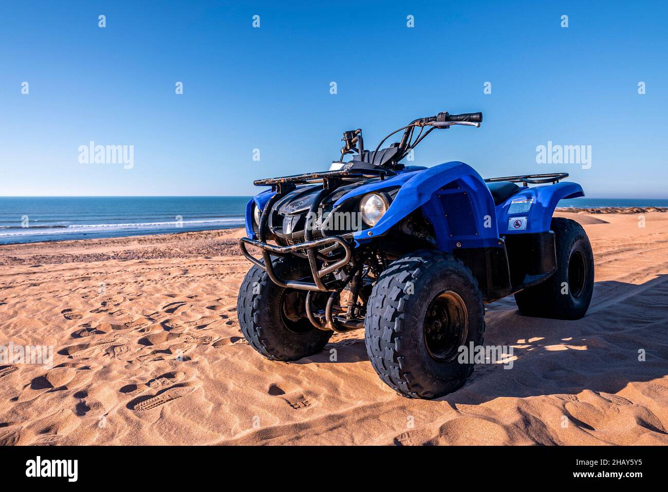 Four wheeler quadbike on sand at beach on bright sunny day Stock Photo ...