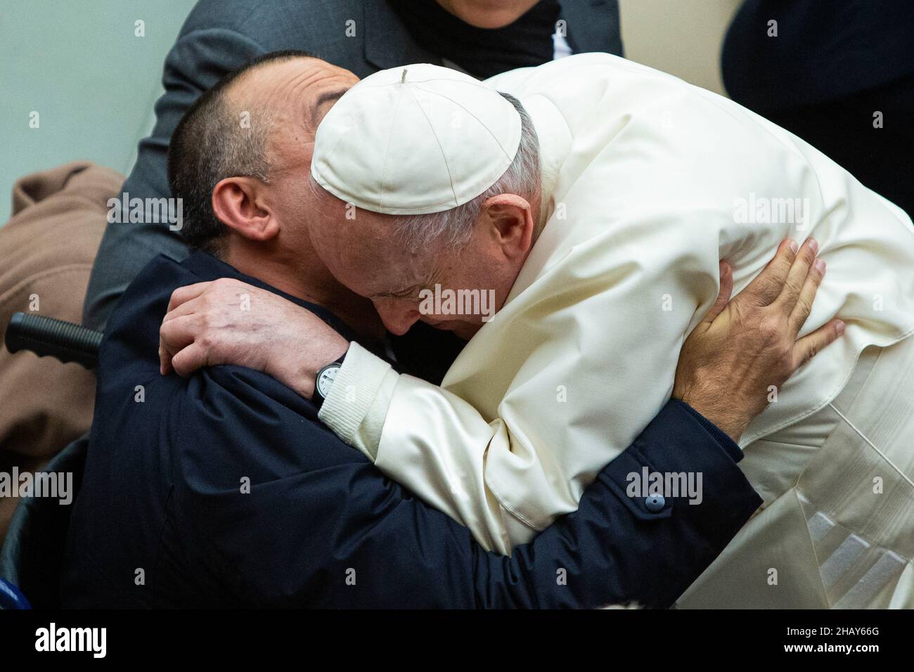 Pope Francis hugs faithful man during the general audience. Traditional ...