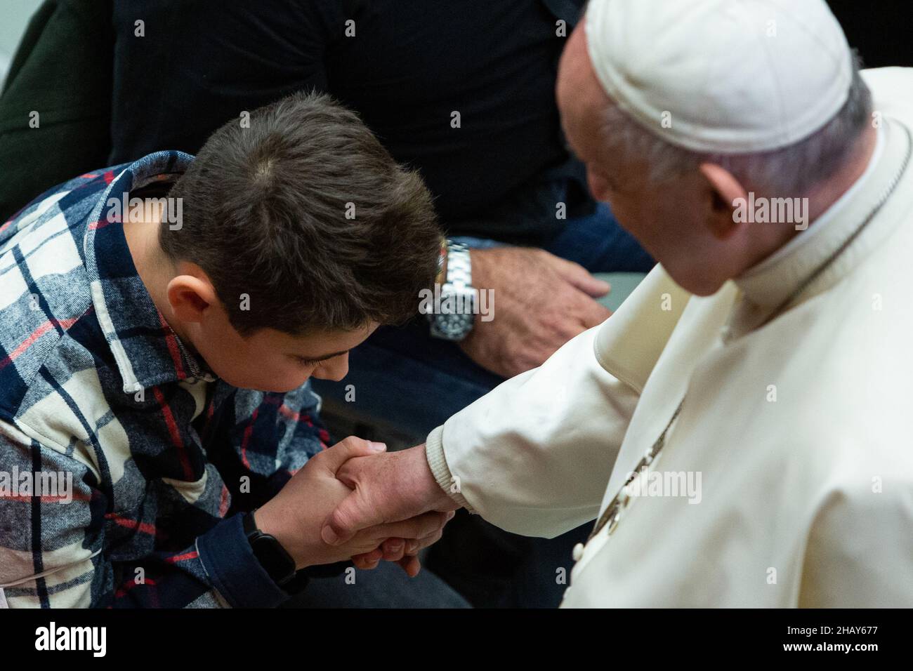 Vatican City, Vatican. 15th Dec, 2021. Pope Francis hugs faithful kid ...