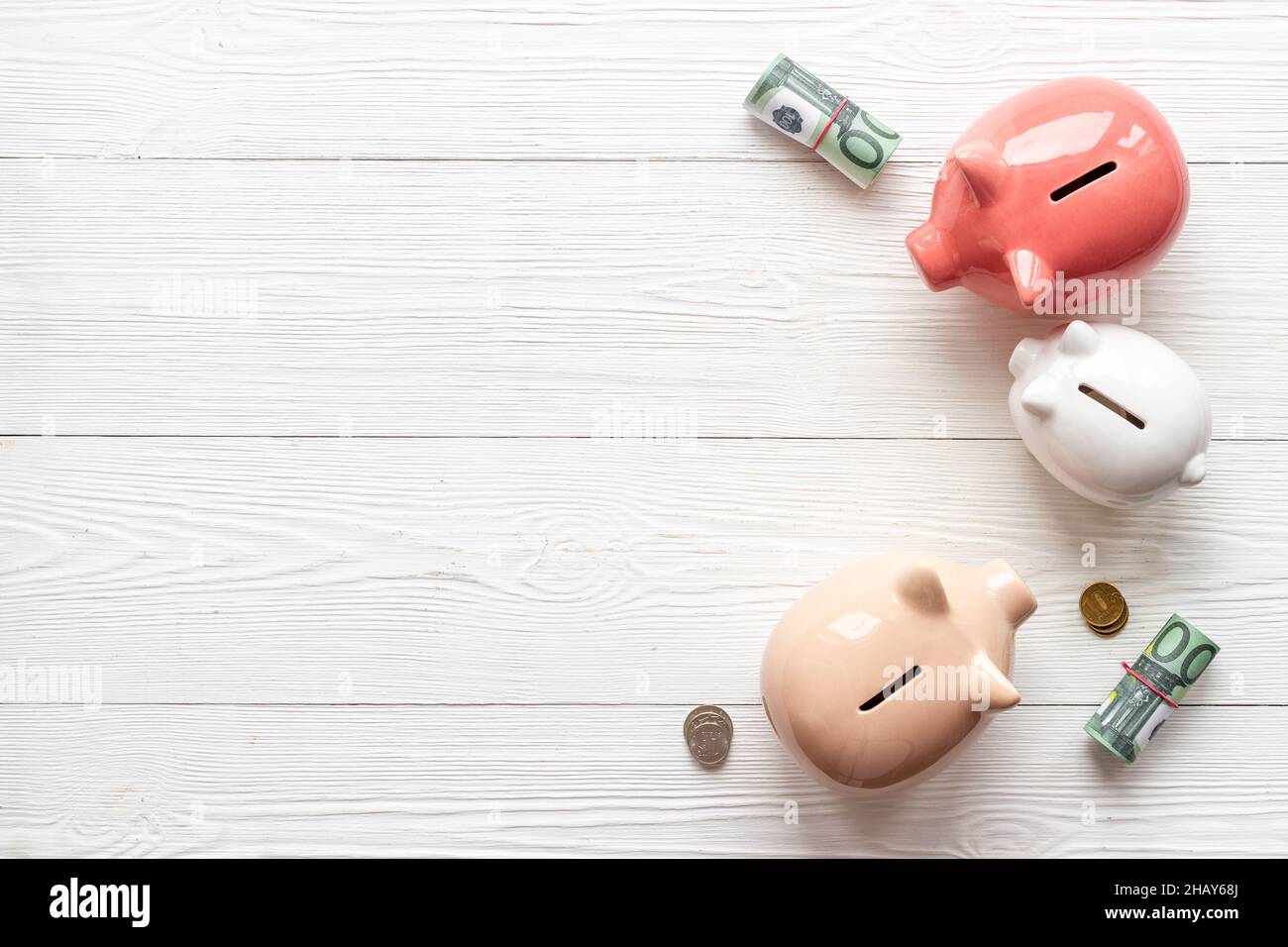 Piggy banks with coins. Currency saving and investments concept Stock ...