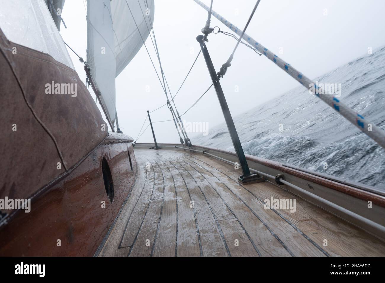 Board of a sailing boat in the wavy sea under a clear sky, Maine, USA ...
