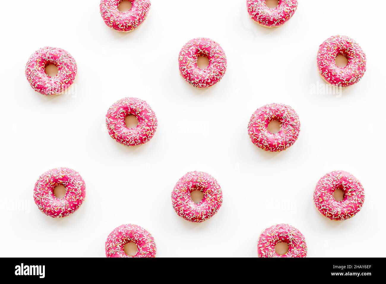 Pink donuts with sprinkles set, top view. Sweet bakery background Stock ...