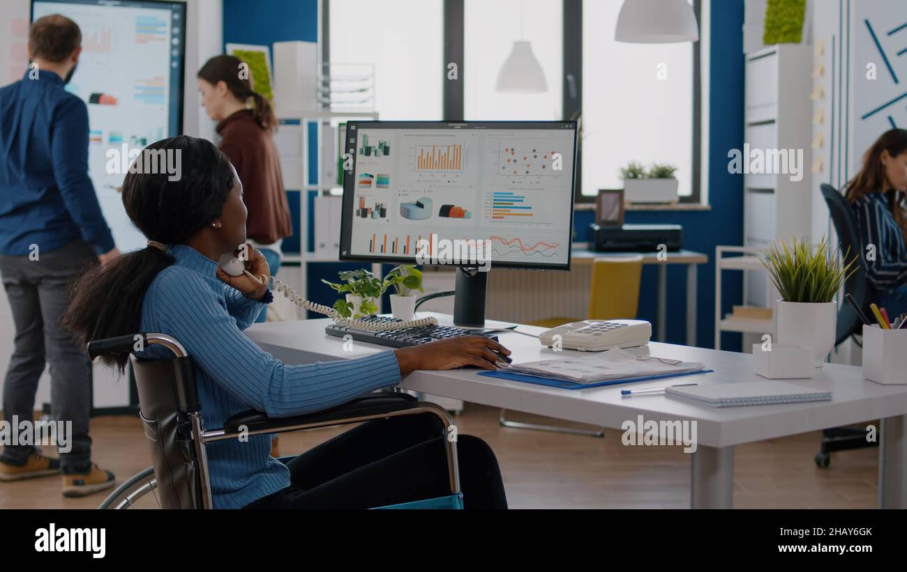 Invalid disabled handicapped african businesswoman sitting in ...