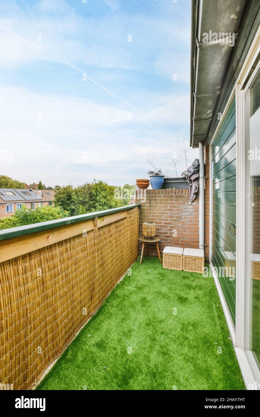 Delightful and mind-blowing balcony with green artificial turf Stock ...
