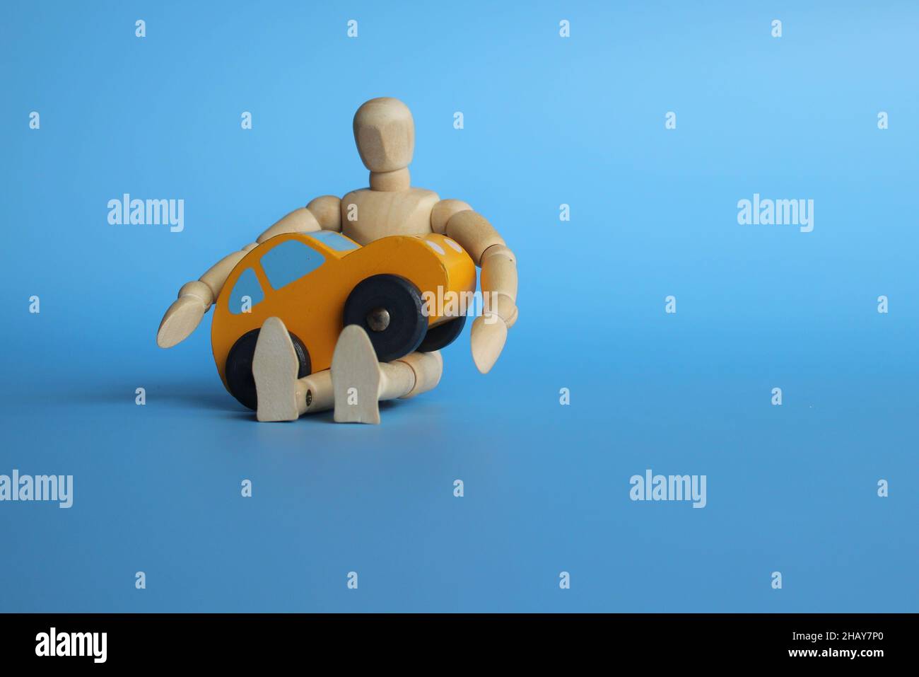Car insurance and protection concept. Wooden human figure hug toy car ...