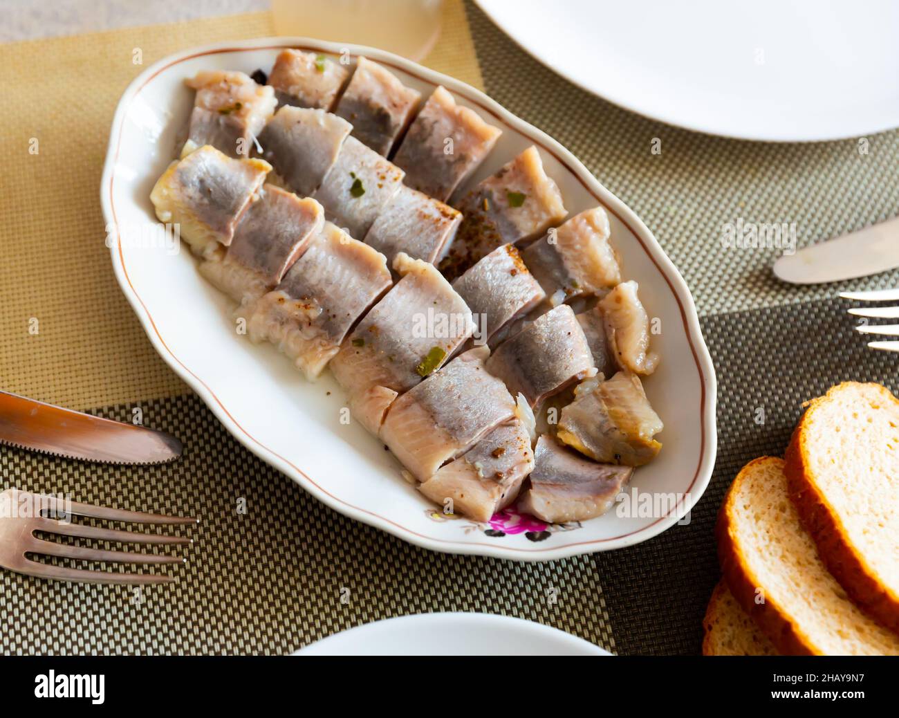Salted pickled herring fish served on a ceramic plate Stock Photo - Alamy
