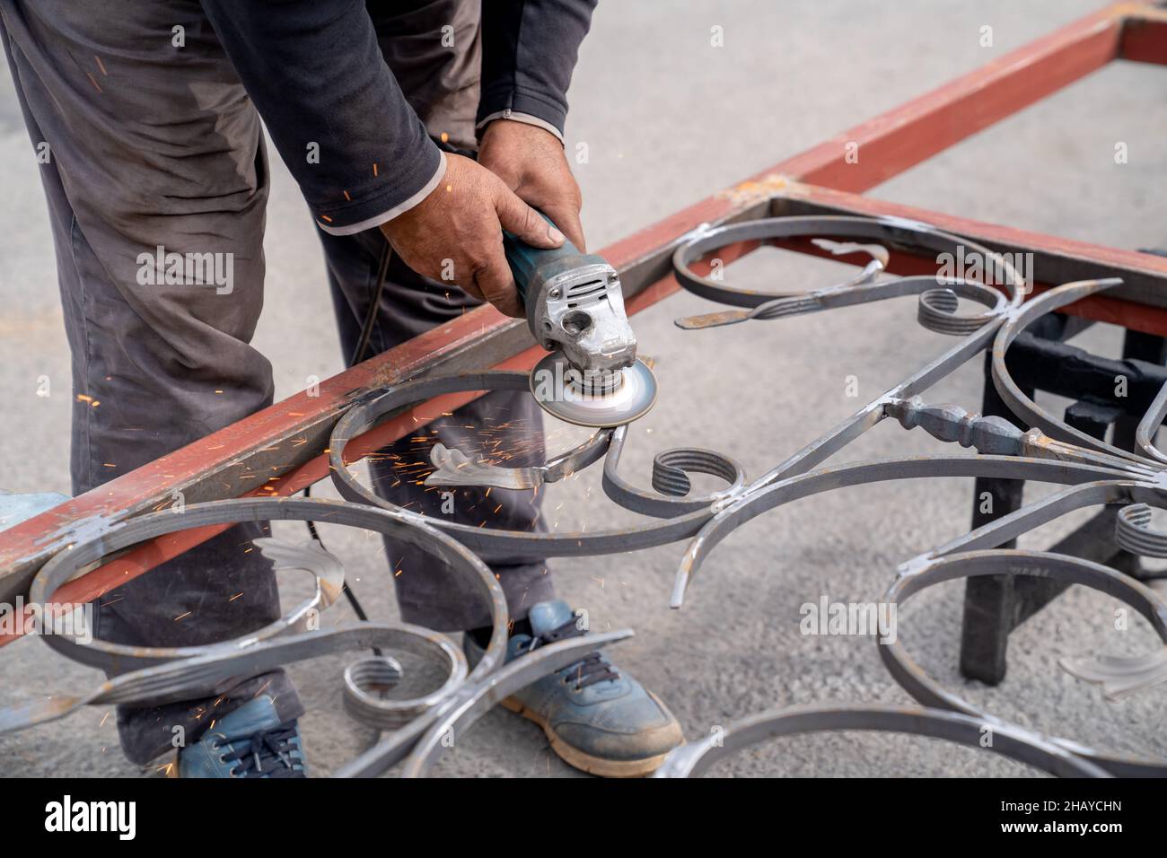 Metal grinding with angle grinder in metal workshop. Sparks fly on the ...
