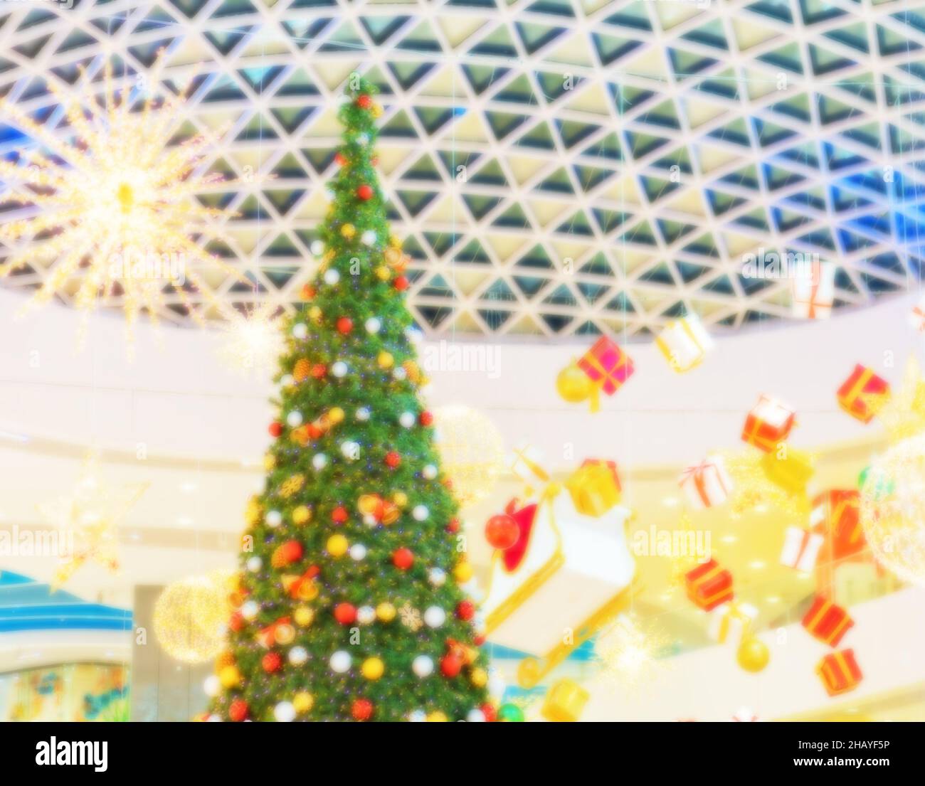 Christmas tree with boxes and decorations suspended from the ceiling ...