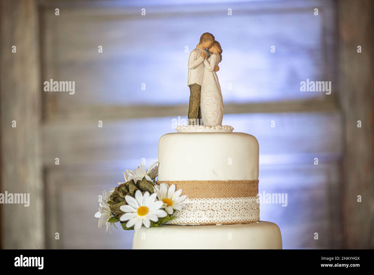 Earthy three tier wedding cake with canvass lace and bows and ...