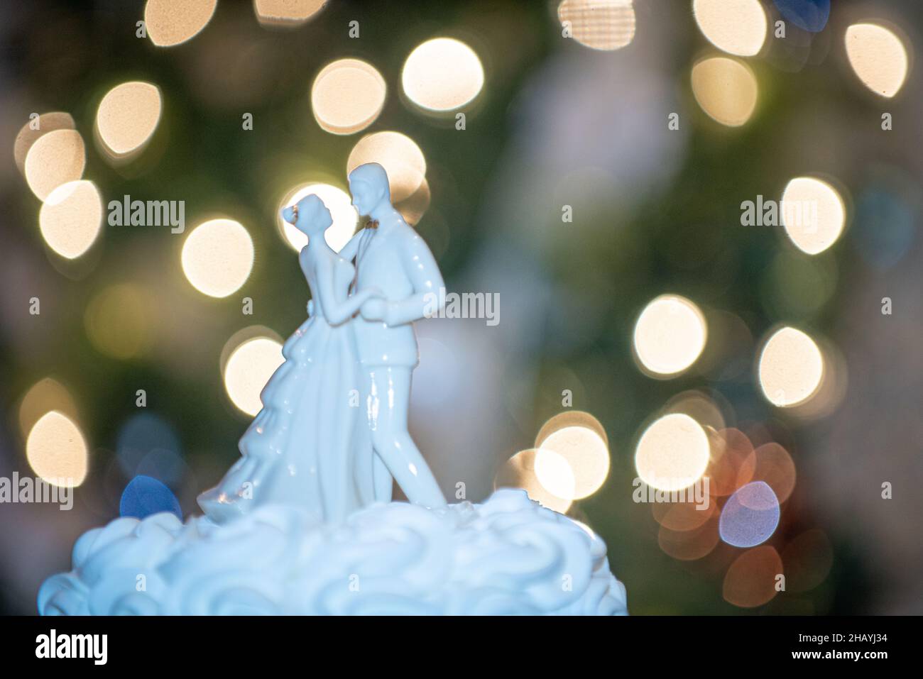 Bride and Groom Cake topper on four layer cake with bokeh christmas ...
