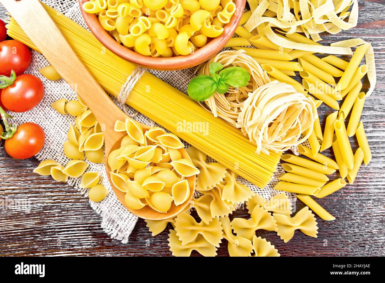 Pasta seashells in spoon, pipe rigate in a bowl, spaghetti, tagliatelle ...