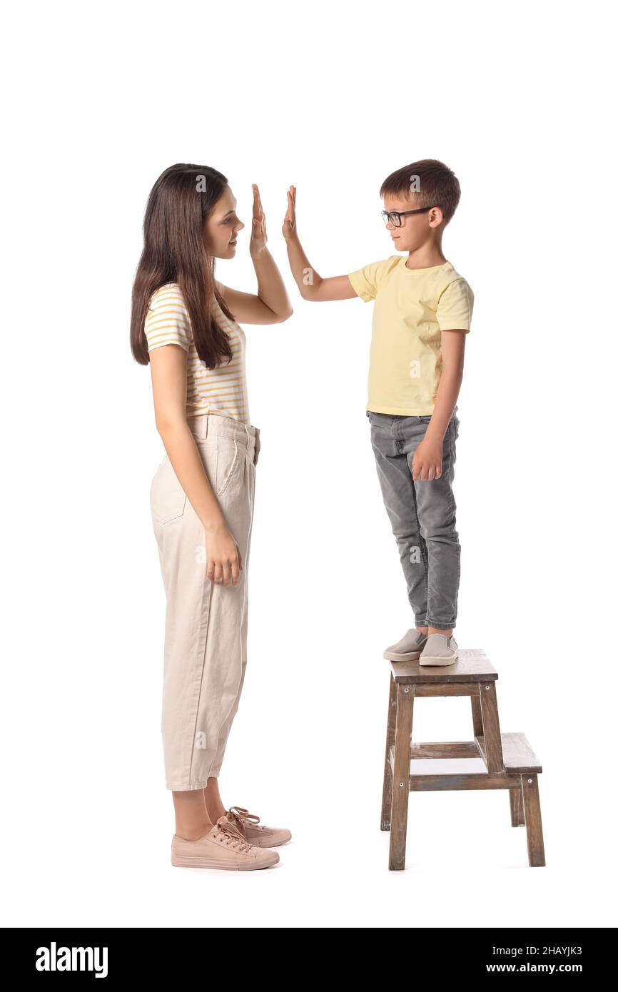 Teenage girl and her little brother giving each other high-five on ...