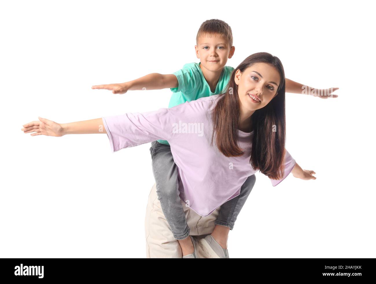 Teenage girl carrying pickaback her little brother on white background ...