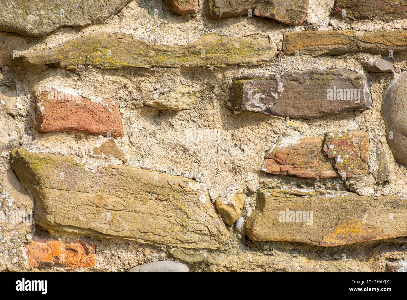 wall lined with different stones and bricks Stock Photo - Alamy