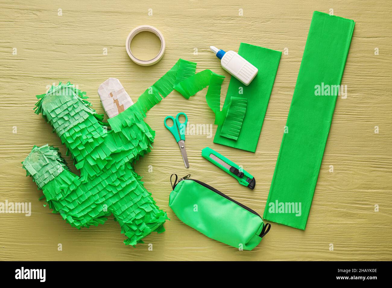 Materials for making Mexican pinata in shape of cactus on color wooden ...
