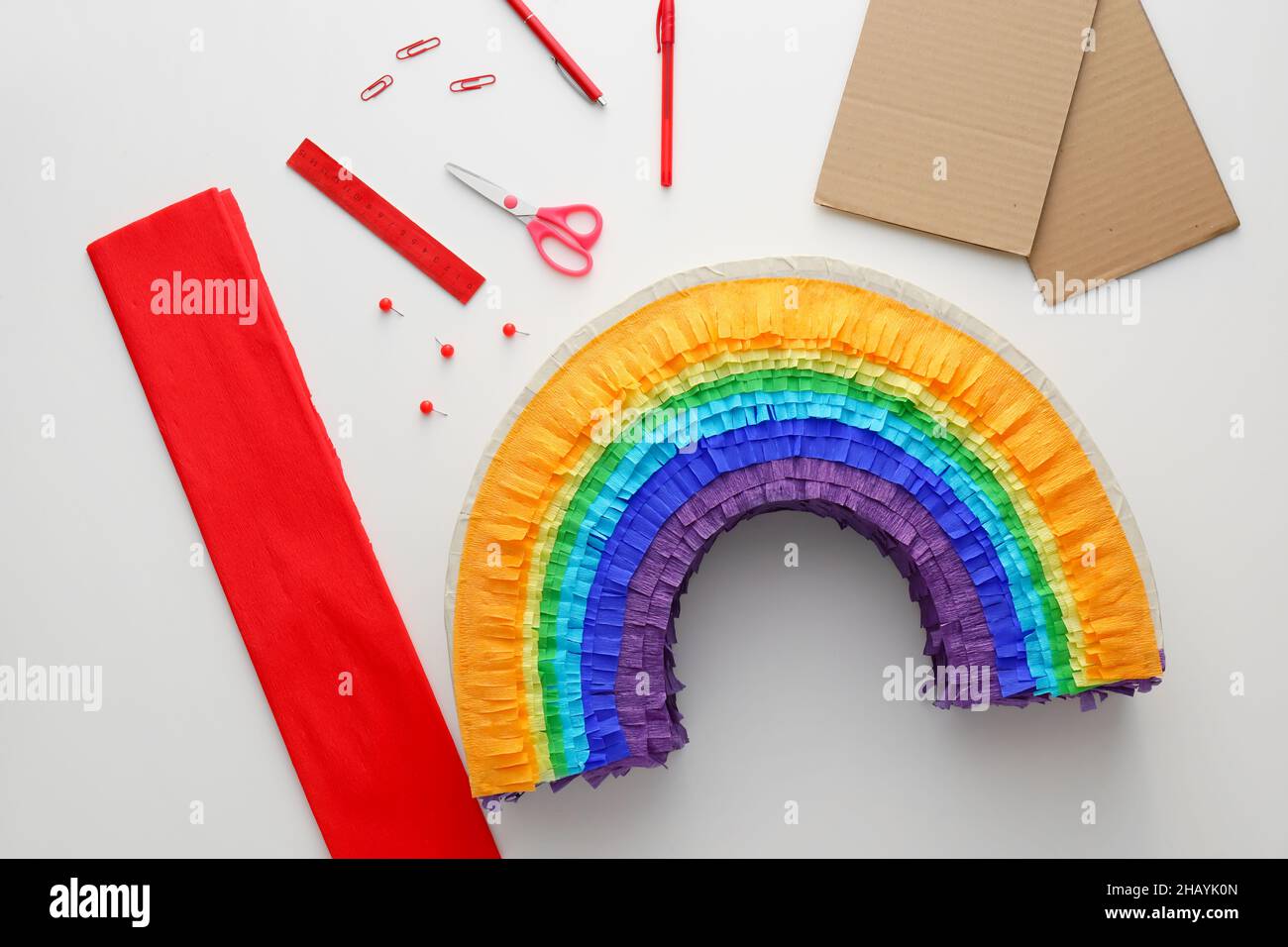 Materials for making Mexican pinata in shape of rainbow on white ...