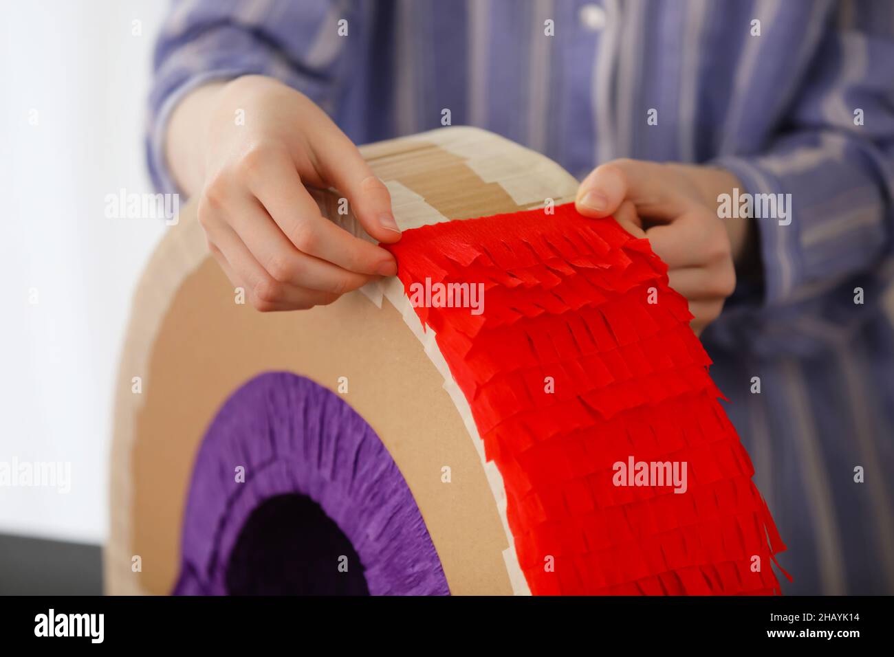 Woman making Mexican pinata in shape of rainbow at home, closeup Stock ...