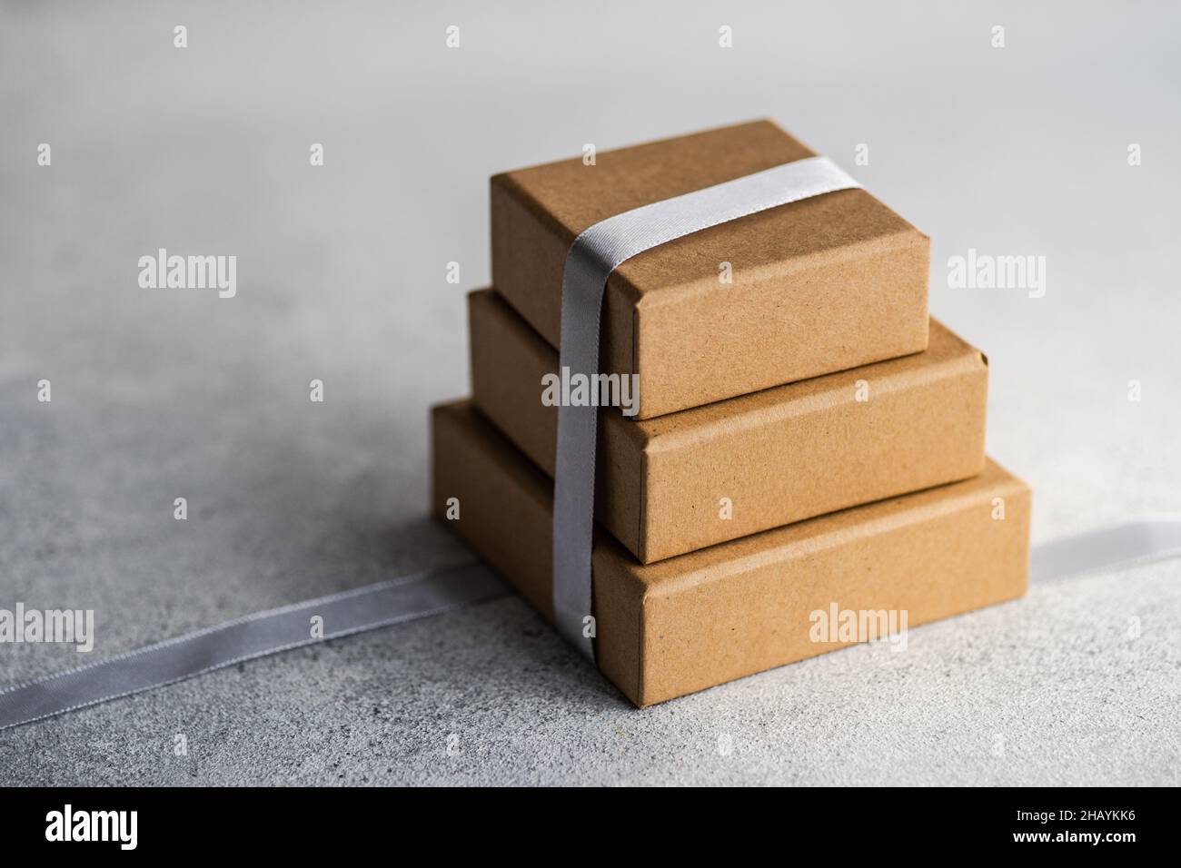 Stack of three gift boxes and a ribbon Stock Photo - Alamy