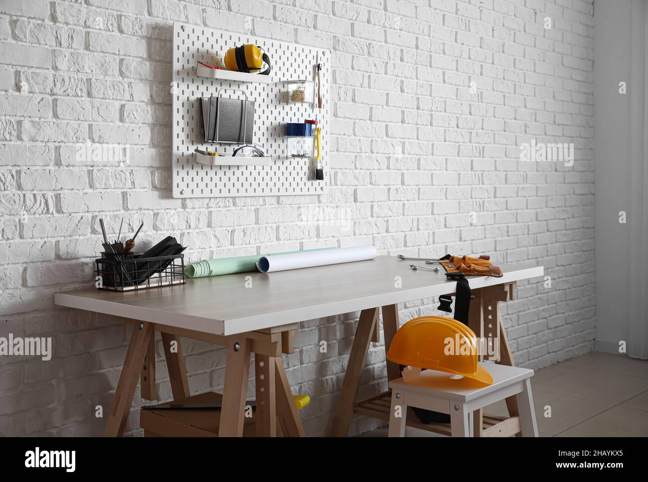 Workplace of engineer with peg board on wall Stock Photo - Alamy