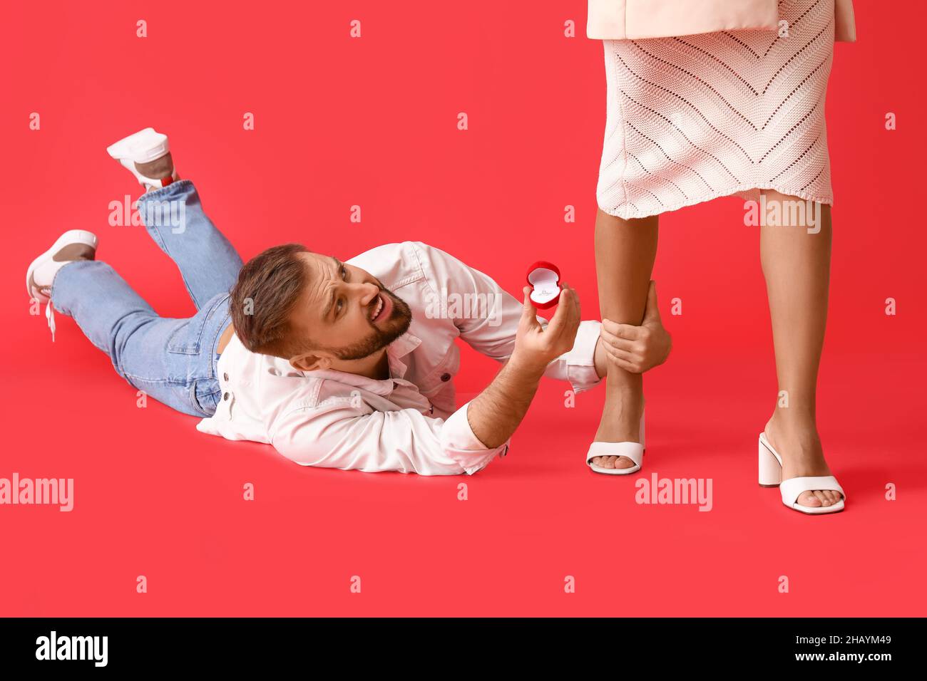 Young woman rejecting marriage proposal on color background Stock Photo ...
