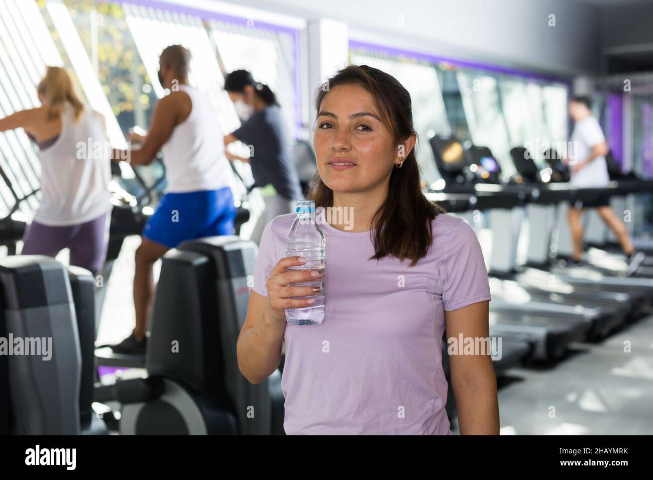 Woman resting after exercises with still water Stock Photo - Alamy