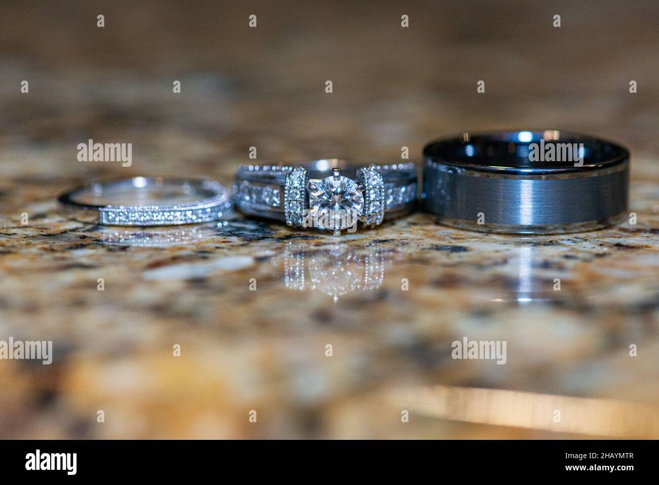 white gold wedding rings with diamonds on Granite countertop Stock ...