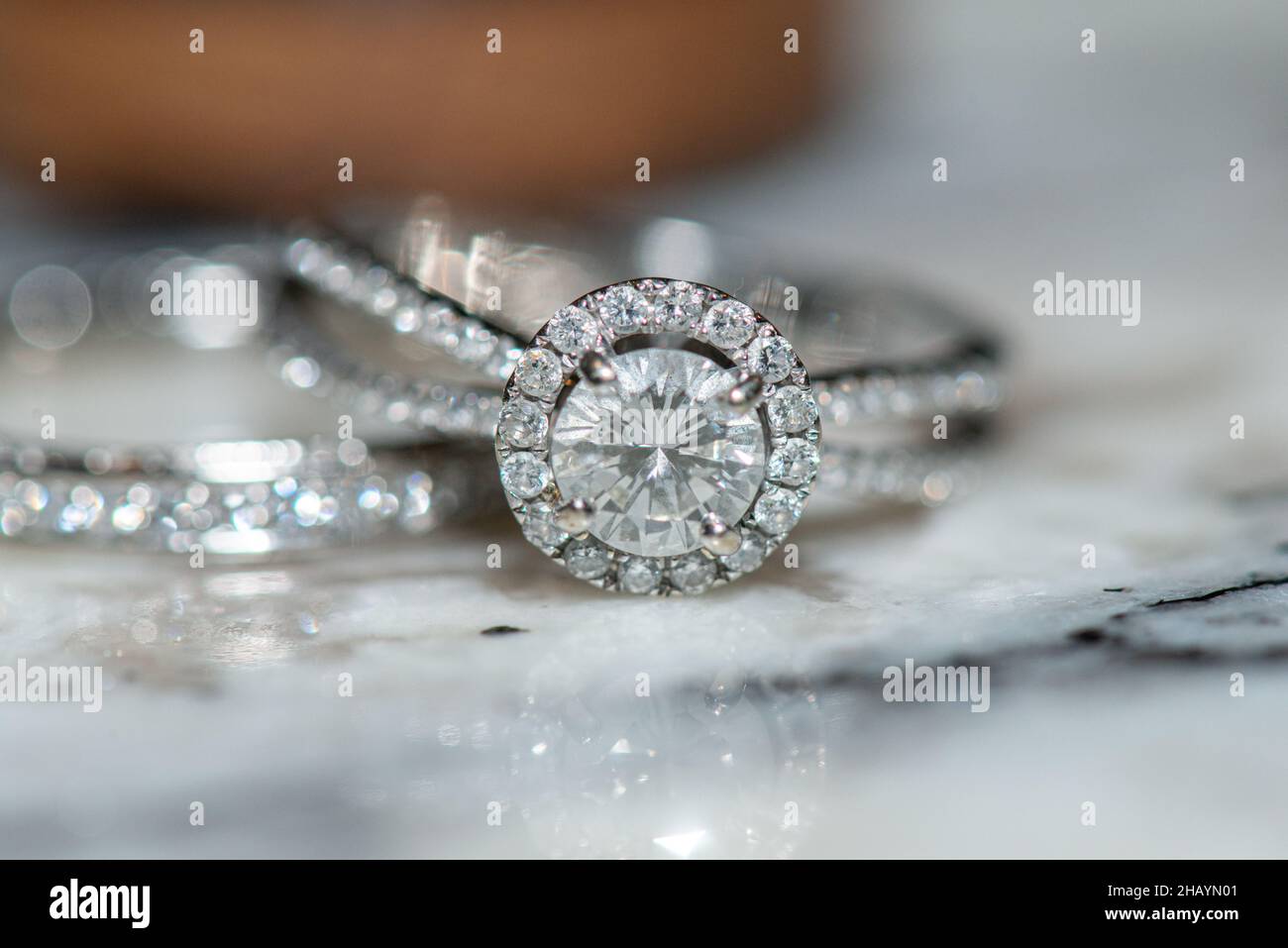 White gold bride and grooms wedding rings with diamonds on reflective ...