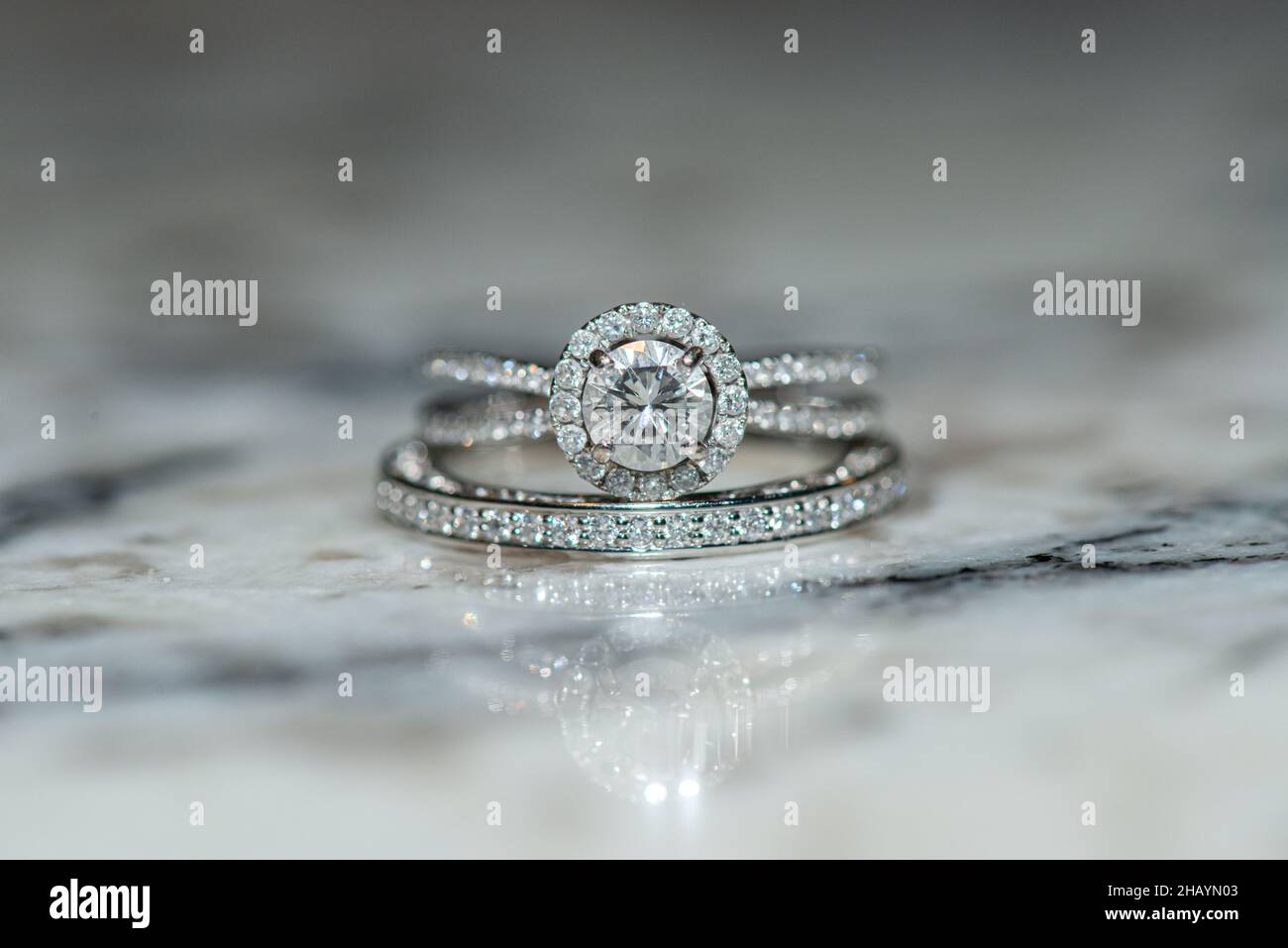 White gold bride and grooms wedding rings with diamonds on reflective white granite Stock Photo ...