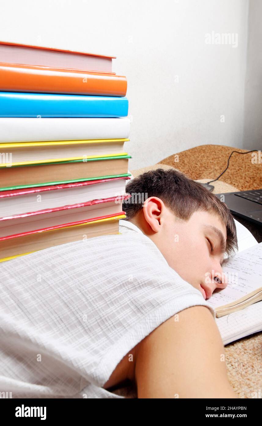 Tired Teenager sleeping on the Sofa with the Books Stock Photo - Alamy
