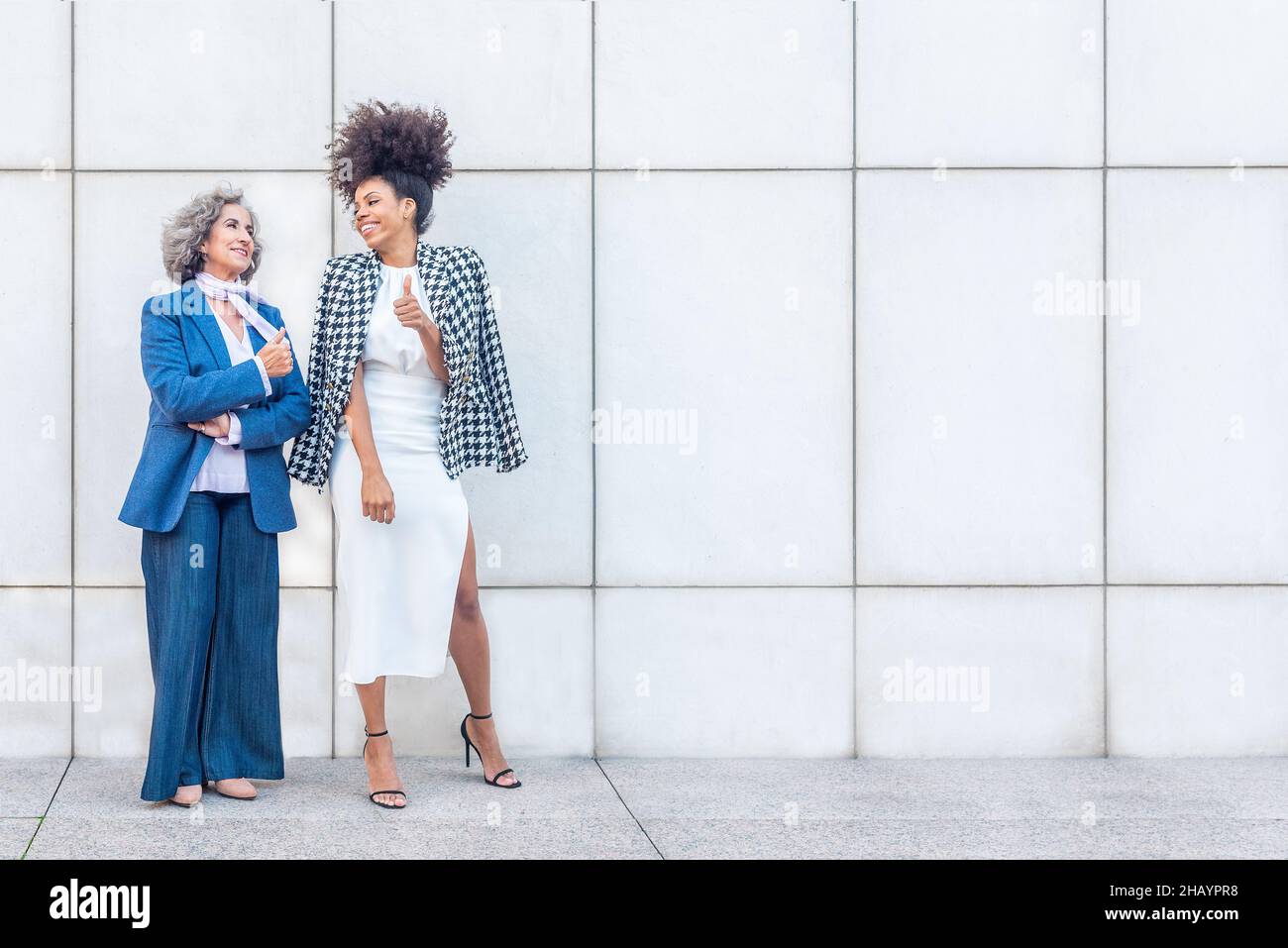 two women laughing while enjoying a break from work Stock Photo - Alamy