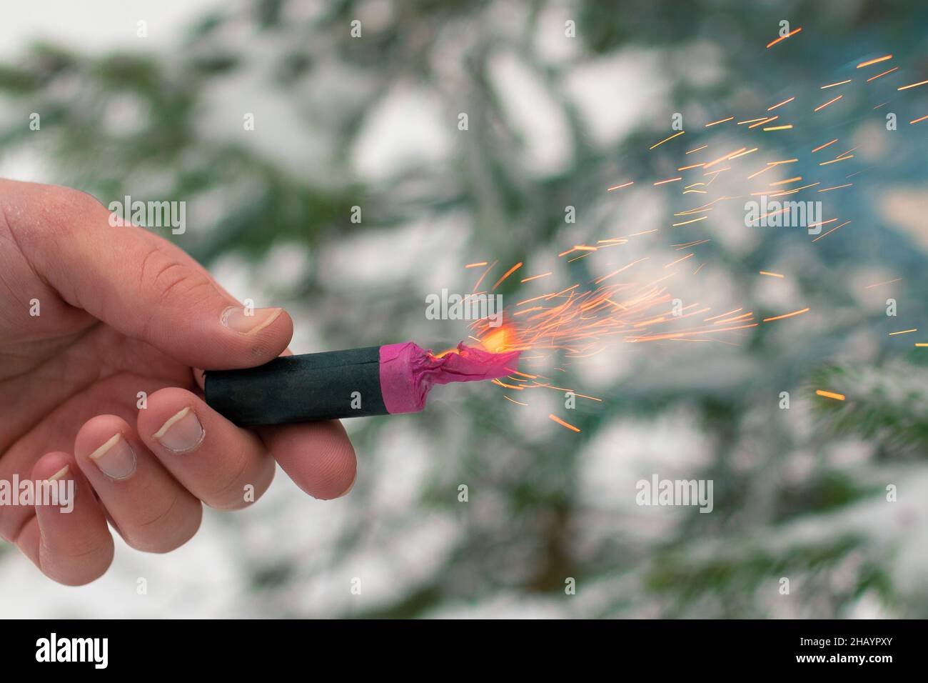 Burning Firecracker in a Hand. Guy Holding a Petard Outdoors in Winter ...