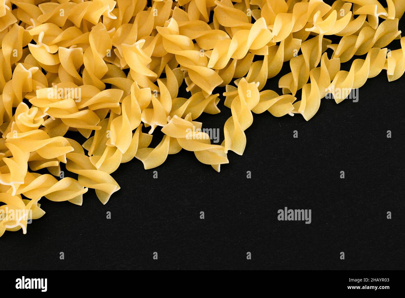 Uncooked Fusilli Pasta with Copy Space on Black Background. Raw and Dry ...