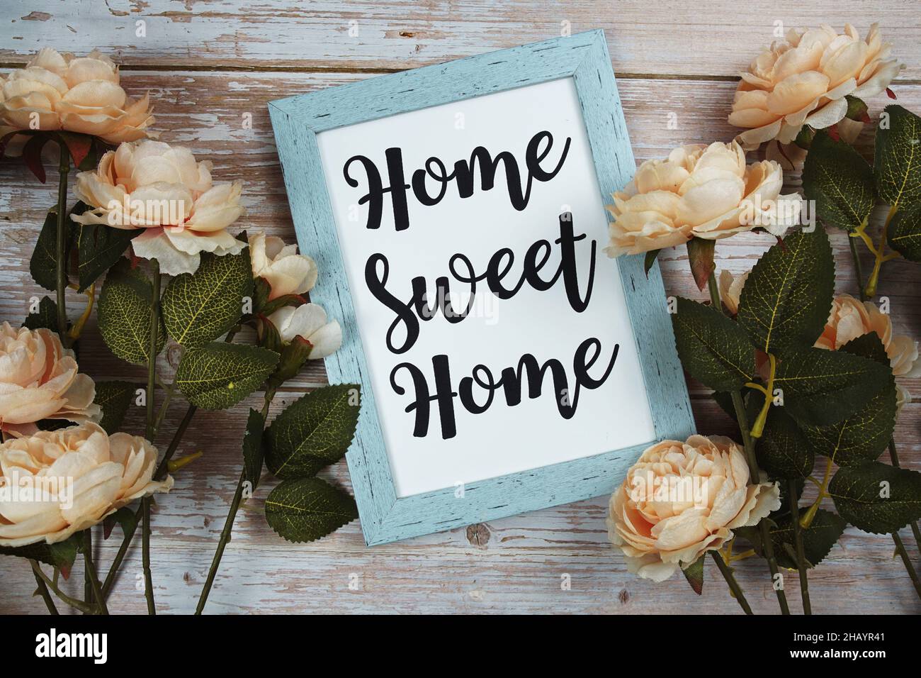 Home Sweet Home typography text with flower decoation on wooden ...