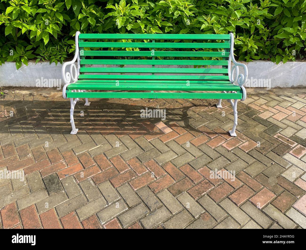 A beautiful siting bench placed in a park with quite and green ...