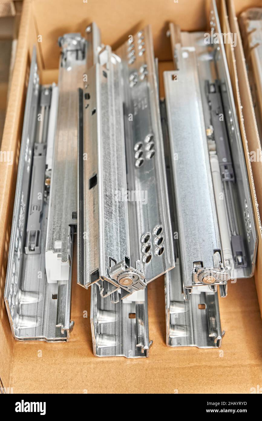 Drawer system slide folded into a cardboard box during production in ...