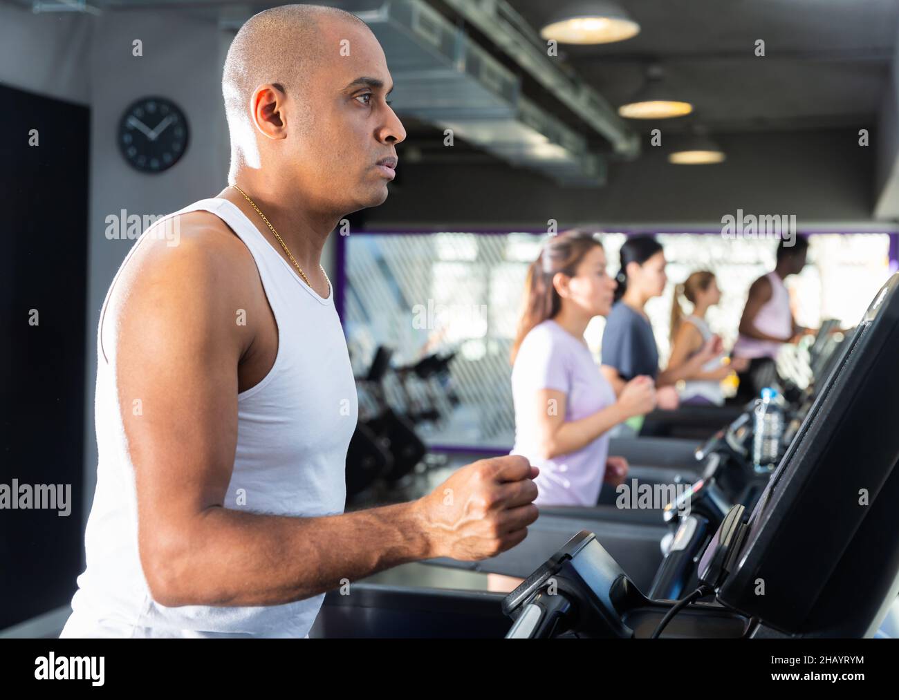 Man training on treadmill at fitness center Stock Photo - Alamy