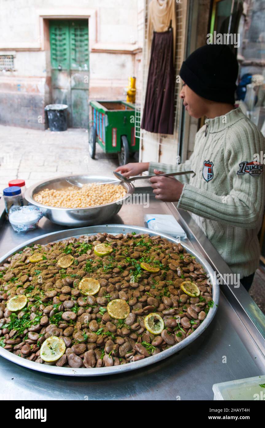 A mobile snack vendor selling cooked fava beans and Lupini beans in the ...