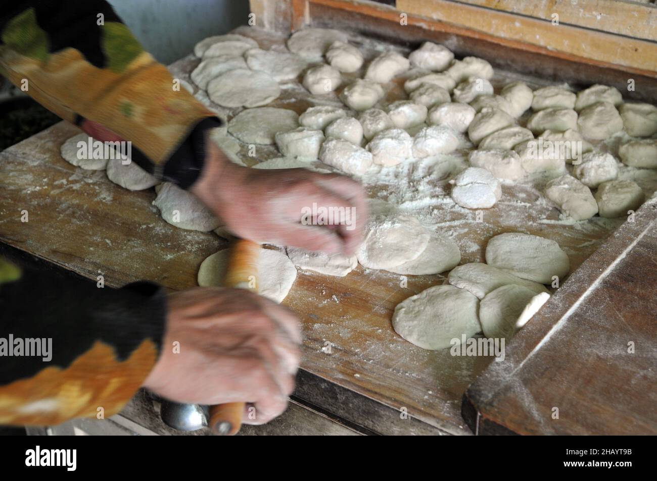 A Uyger woman prepares fresh dumplings for breakfast in Xinjiang China ...