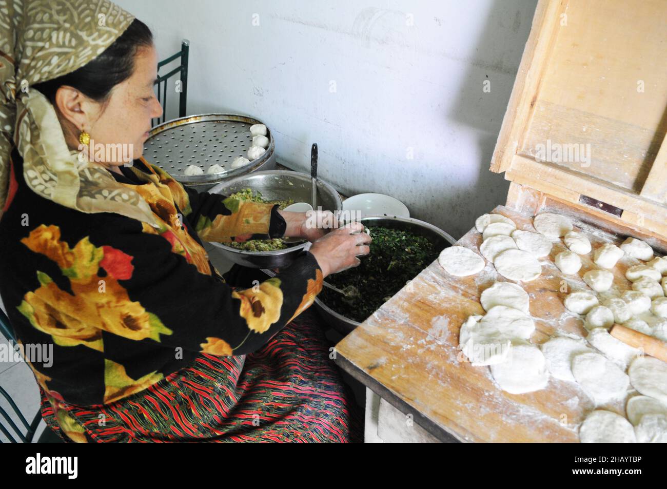 A Uyger woman prepares fresh dumplings for breakfast in Xinjiang China ...