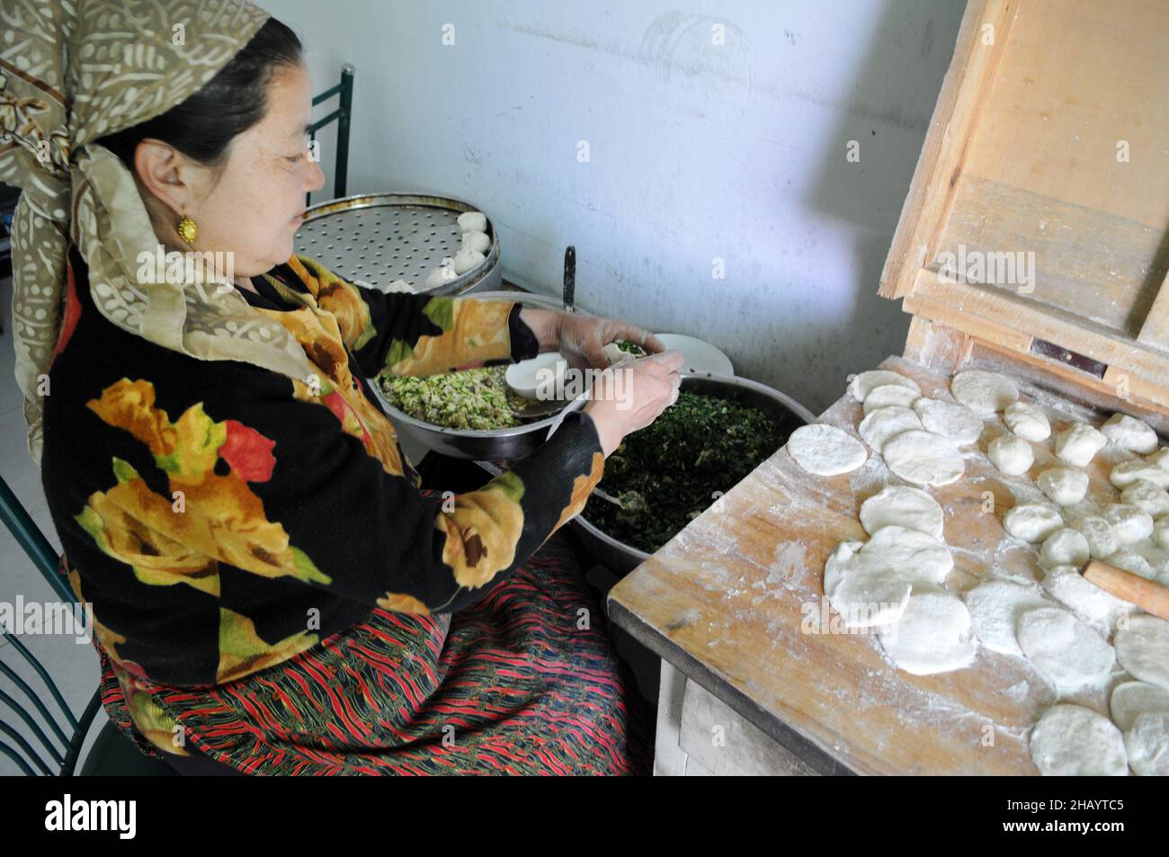A Uyger woman prepares fresh dumplings for breakfast in Xinjiang China ...