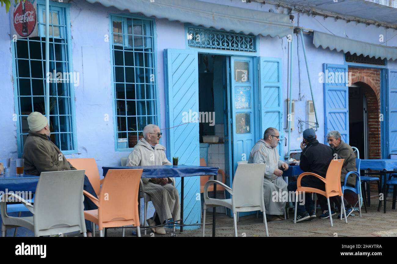 Moroccan men socialize in a local tea shop in the medina of Chefchaouen ...