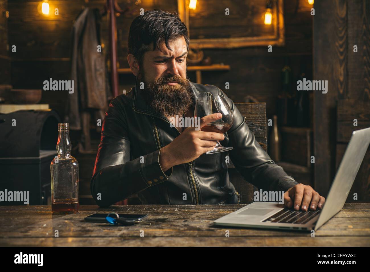 Bearded man is drinking expensive whisky. Old traditional whiskey drink ...