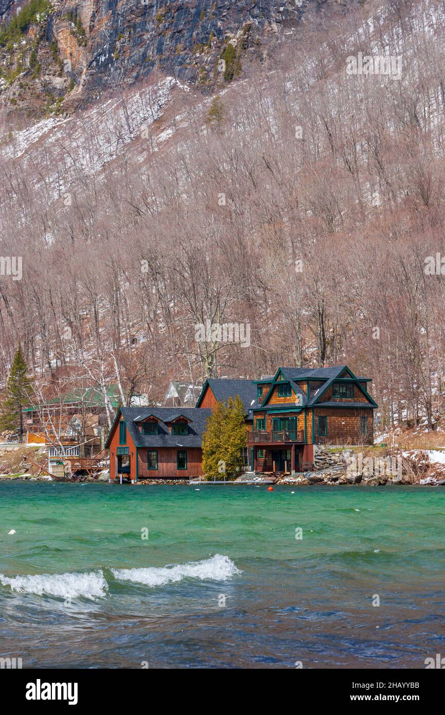 A waterfront single-family house on Lake Willoughby. Mount Pisgah steep ...