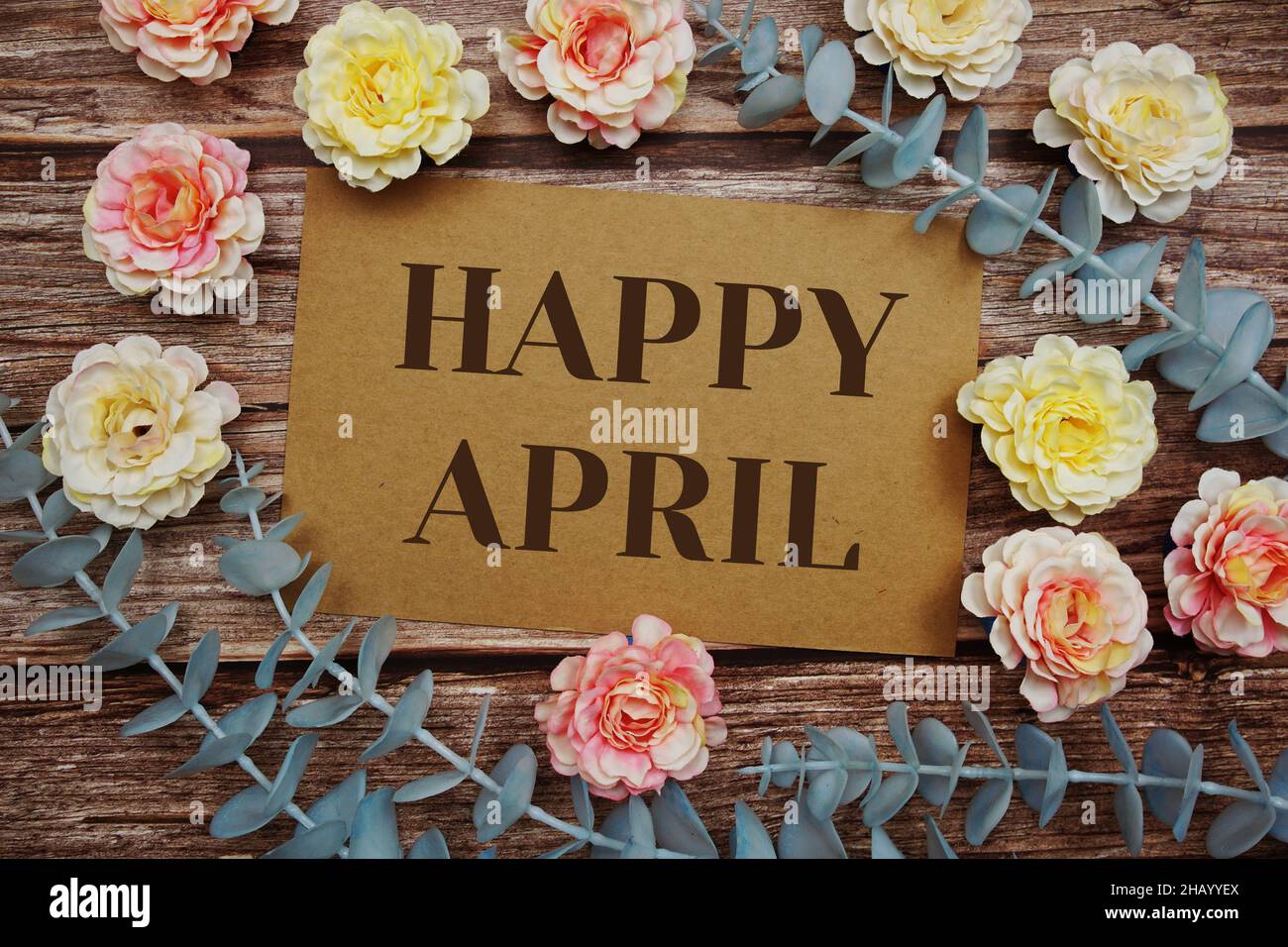 Happy April typography text on paper card decorate with flower on ...